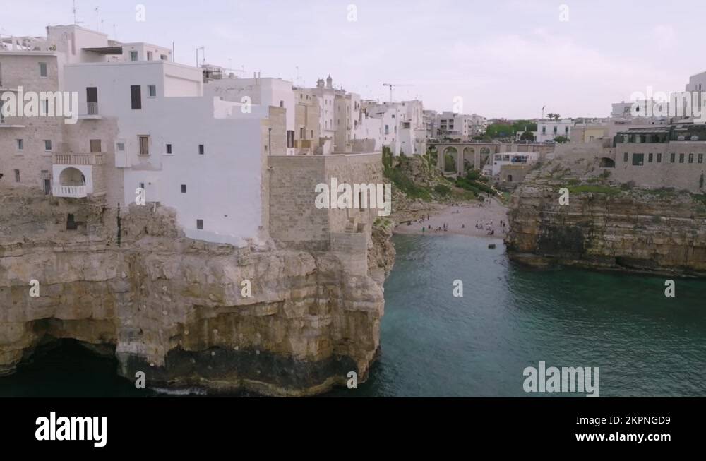 Slow aerial reveal of Lama Monachile beach in Polignano a Mare, Italy ...