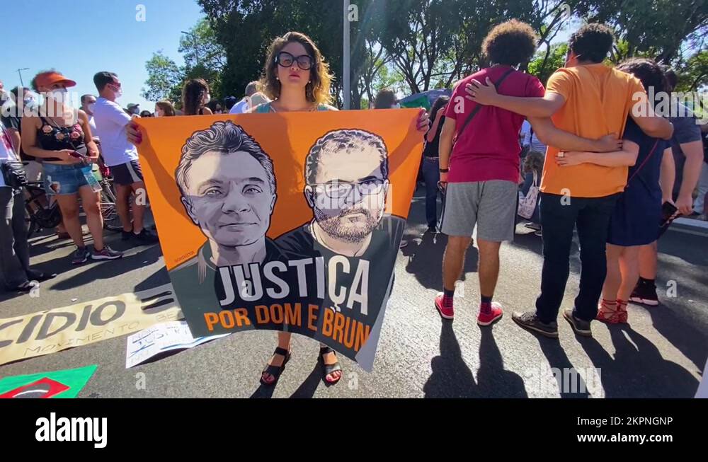 a lady demonstrates with a banner with the photos of the murdered brit ...