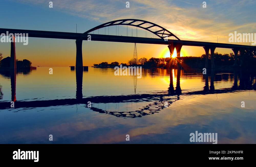 Sunrise bursts from behind bridge pillars Stock Video Footage - Alamy