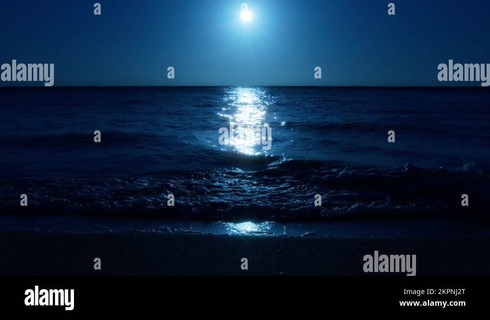 Moonlight over ocean waves washing beach sand, Full moon glowing with ...