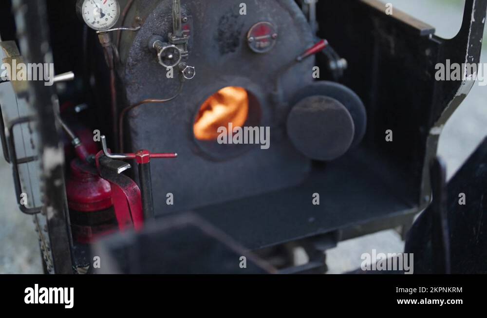 Fire burning inside miniature steam engine locomotive boiler 4K Stock ...