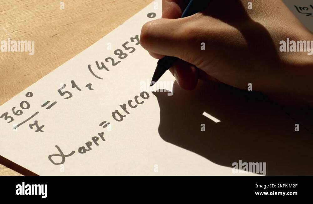 Hand of a young mathematician writing formula with arccos function on a ...