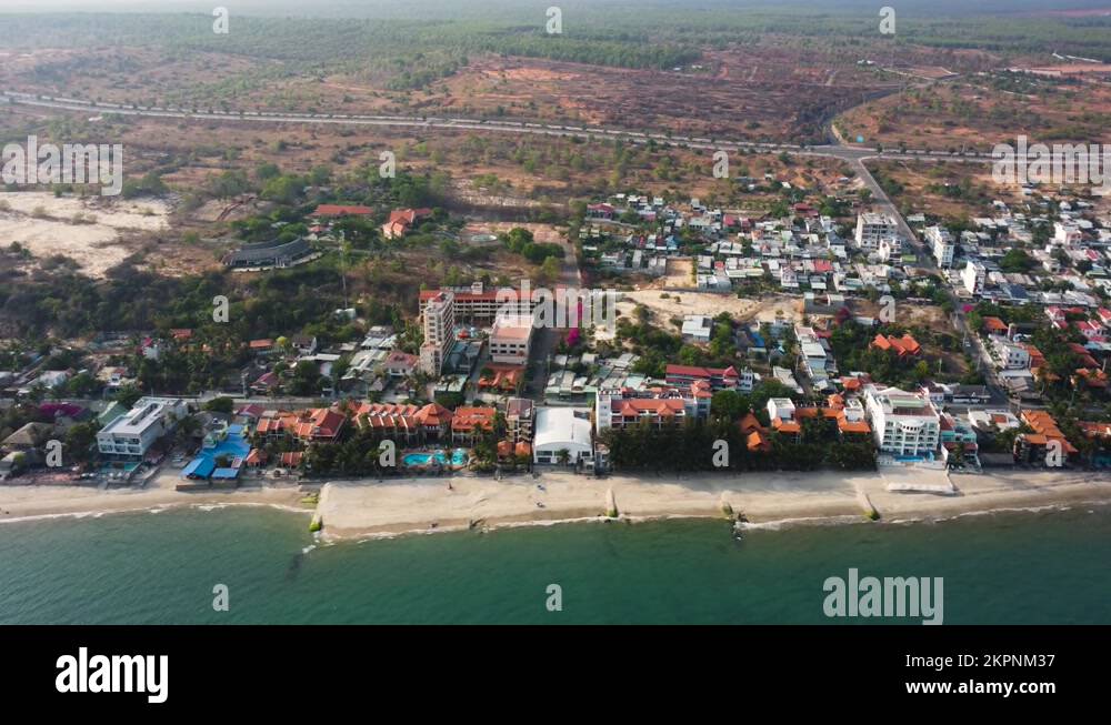 Aerial panning view of Ham Tien with rising sea level and coastal ...