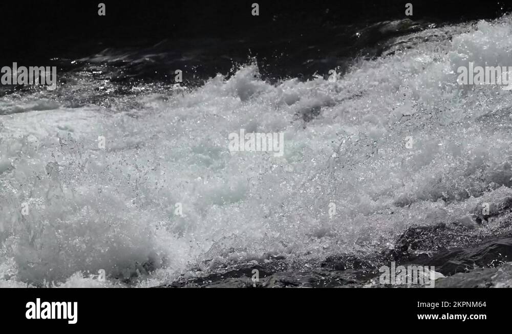 White foam that water create in an alpine river with relief and current ...