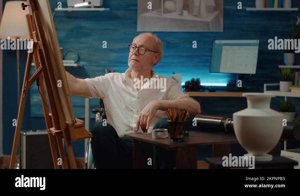 Retired man with chronic disability drawing masterpiece on canvas Stock ...