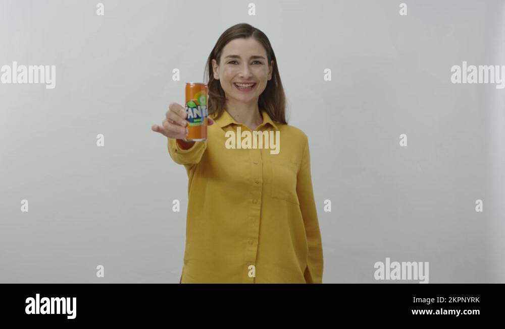 Character portrait of a young woman drinking Fanta from a tin can Stock ...