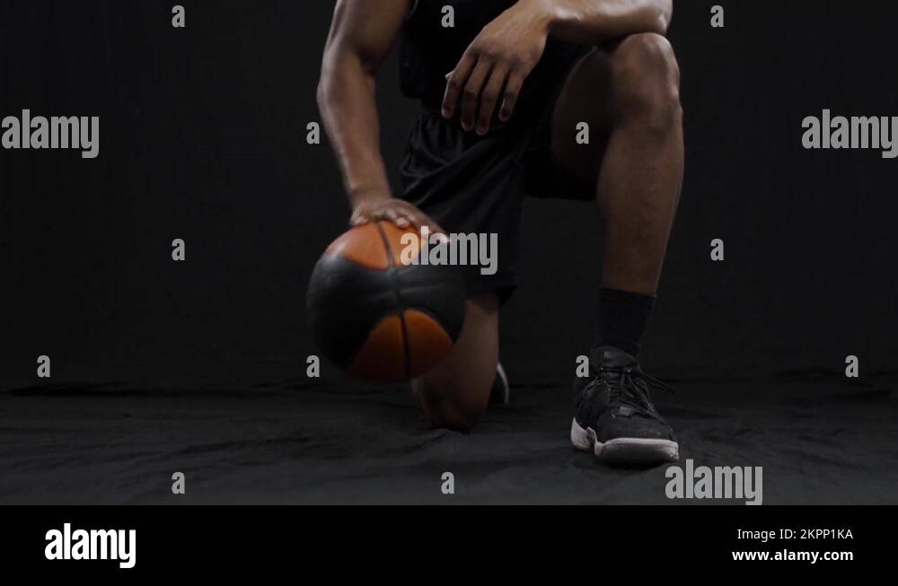 Basketball player bouncing a ball. African american sports man ...