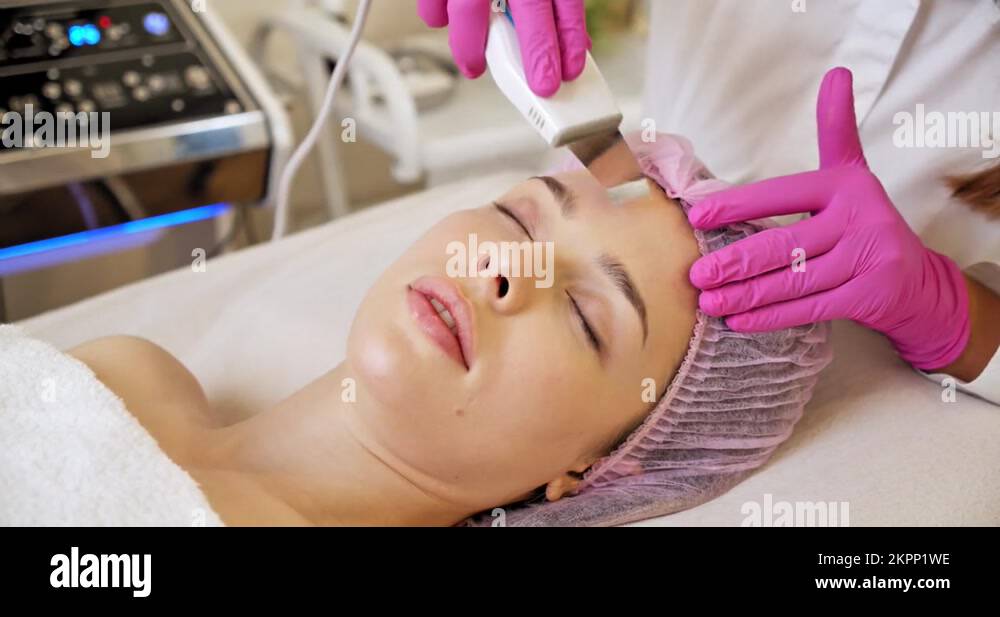 Beautiful woman receiving facial microcurrent treatment at spa salon ...