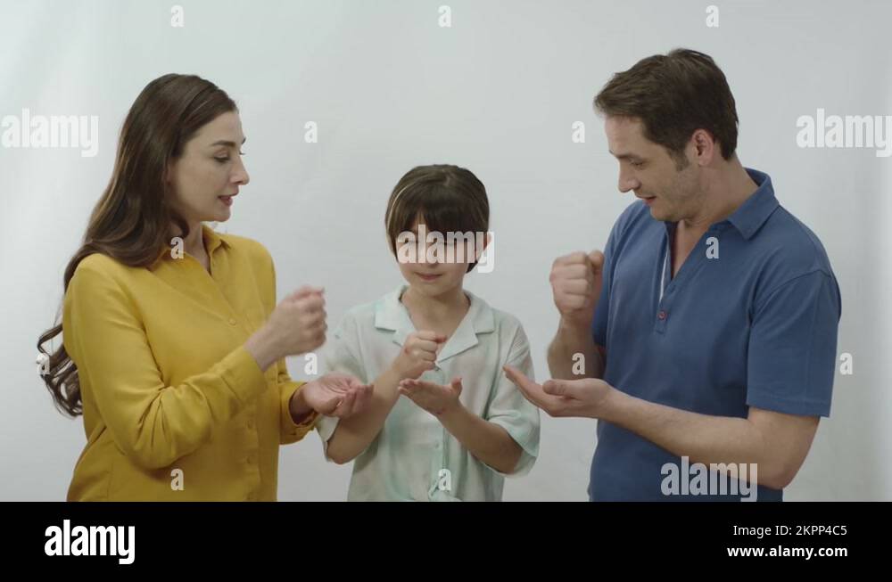 Little girl is playing rock scissors paper game with her parents Stock ...