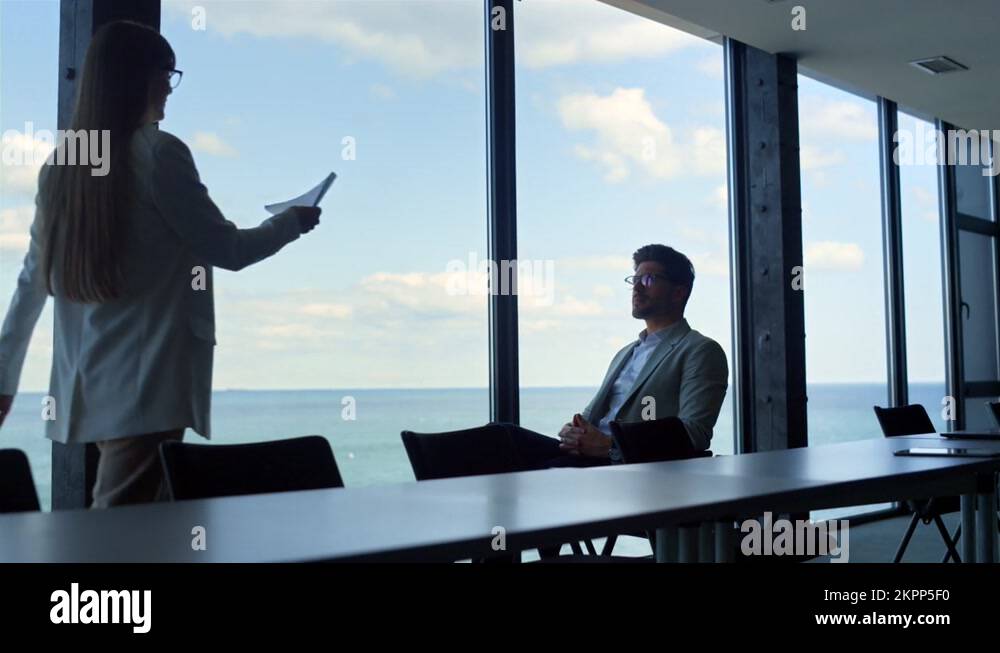 Secretary giving report papers to company manager. Focused professional ...