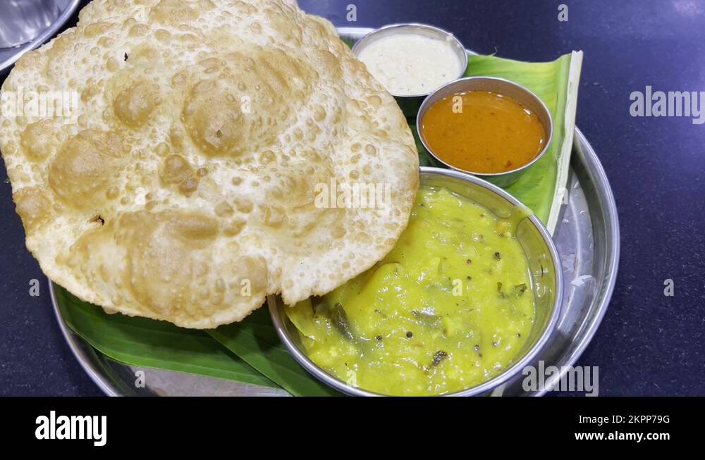 Overview of Indian Food platter consisting of puri, sabji, dal and ...