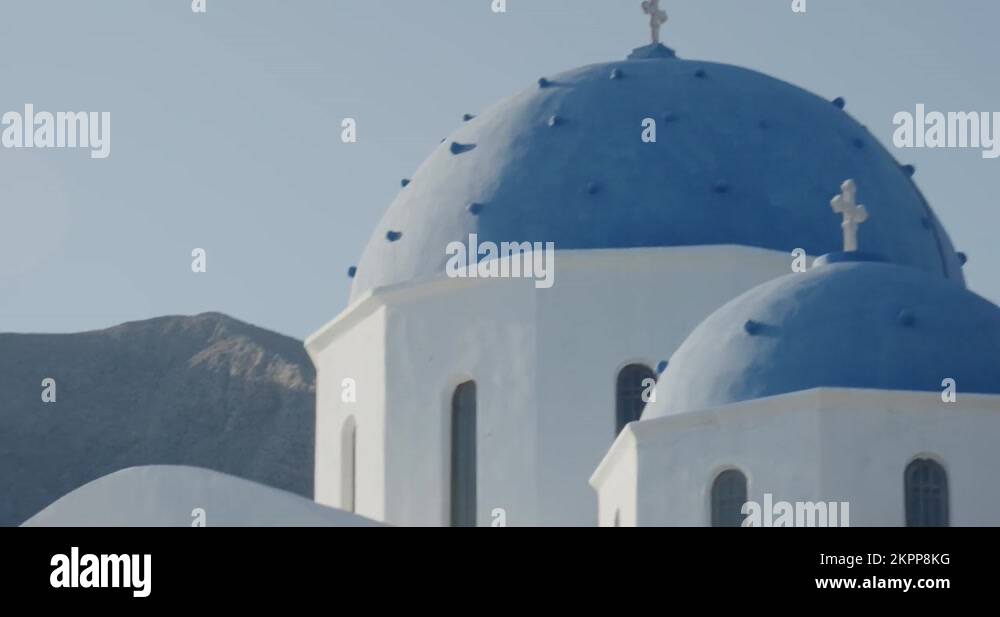 Scenic blue and white Church at the bottom of mountain in Santorini ...