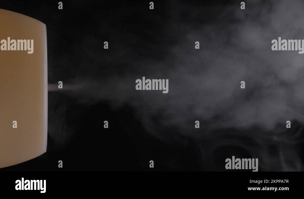 Diffuser for essential oils diffusing steam on black background Stock ...