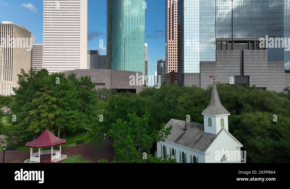 Sam Houston State Park and Texas flag. Rising aerial reveals downtown ...