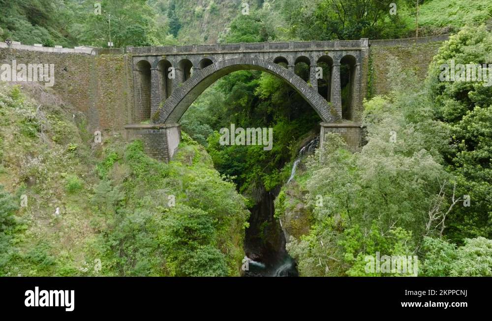 Old arch bridge over ravine in Madeira interior, A Ponte Velha; drone ...