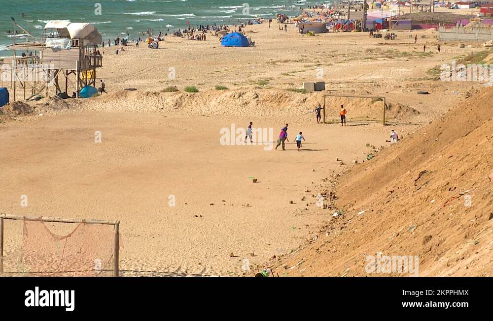 Five boys play football on the beach in Gaza, Palestine. Filmed in slow ...