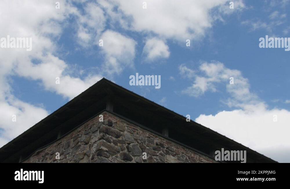 Clouds moving behind watchtower, Auschwitz Birkenau holocaust concept ...