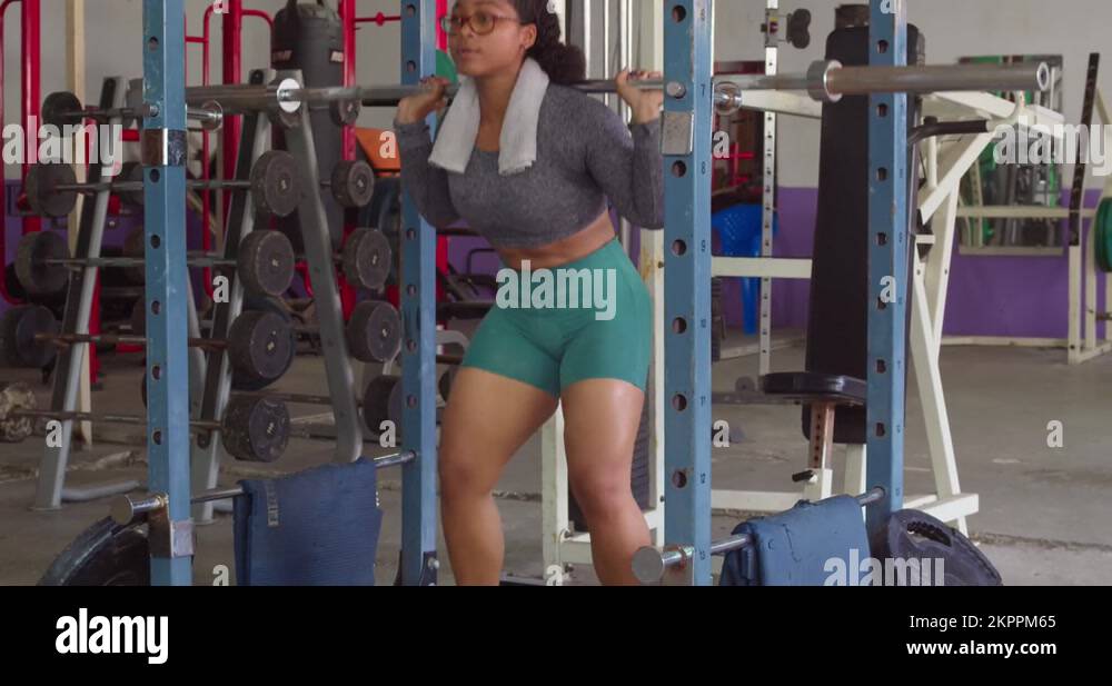 Young fitness model warming up exercises at the gym before an intense ...