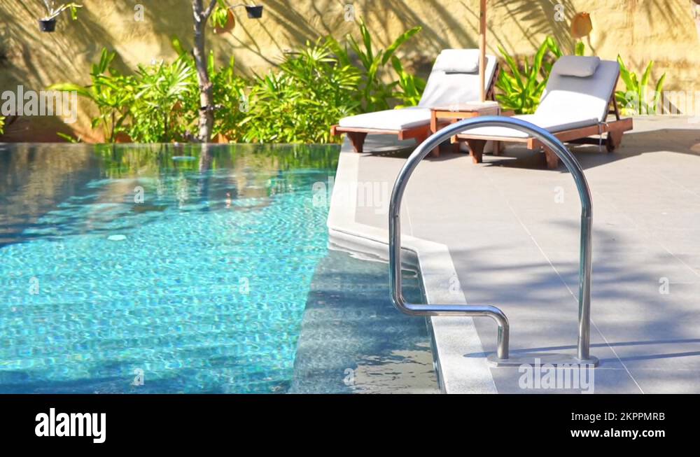 Empty privet villa swimming pool outdoor lounge with two deckchairs ...