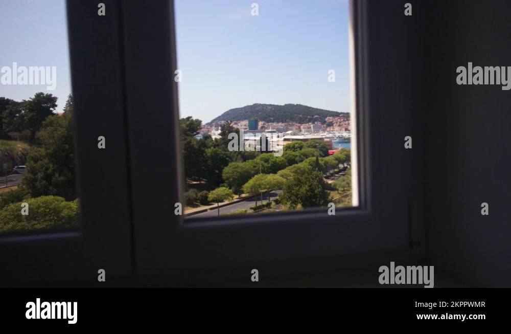 A reveal of a harbour outside while getting closer to a window Stock ...