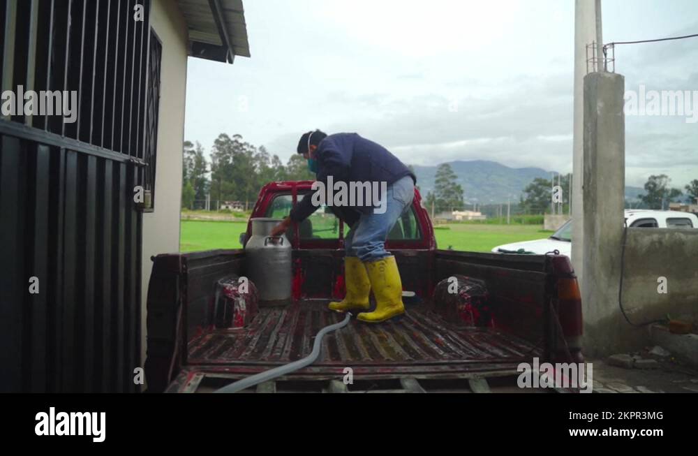 Worker cleaning car from milk buckets in food factory with ...