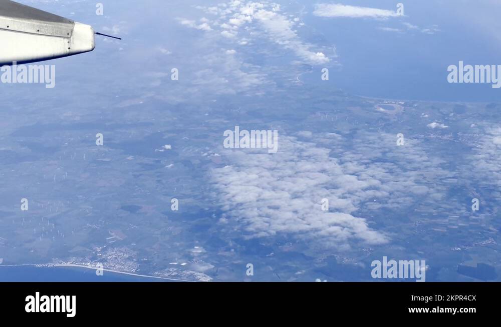 Tilt up passenger pov of jet Airbus A320 airplane wing flying high over ...