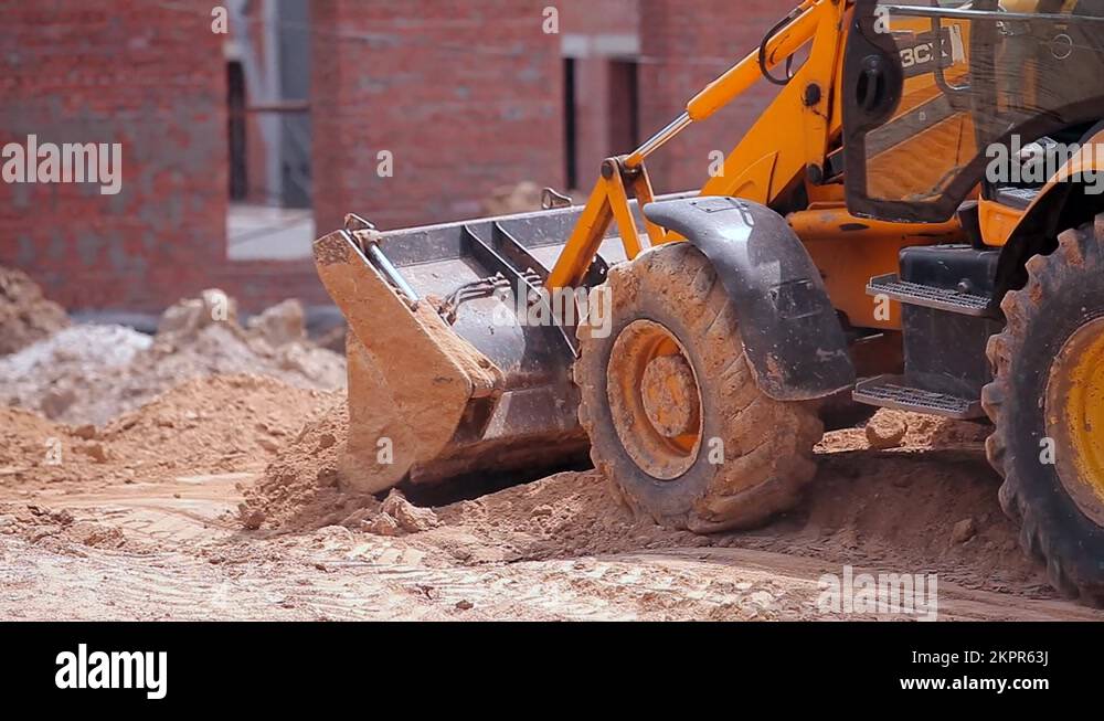 The tractor works at a construction site. Working process at a ...