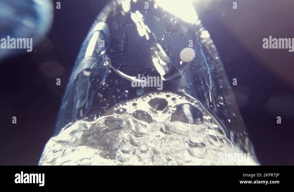 Pouring fresh pure sparkling water into a glass view from below. Selective fo Stock Video ...