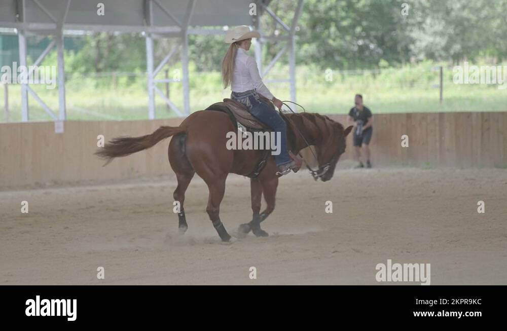 Female cowboy make a fast spin with western horse at competition 4K ...