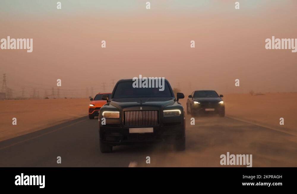 Rolling shot of Rolls Roys Cullinan Lamborghini Urus car driving in ...