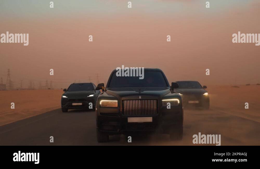 Rolling shot of Rolls Roys Cullinan Lamborghini Urus car driving in ...