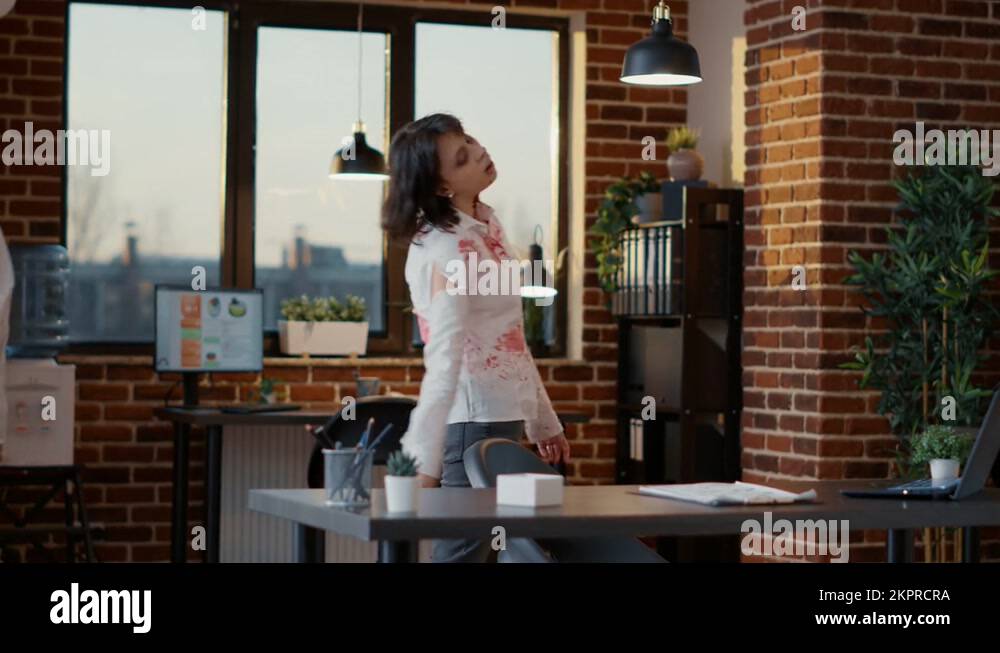 Creepy horror looking zombies wandering around office workplace while ...