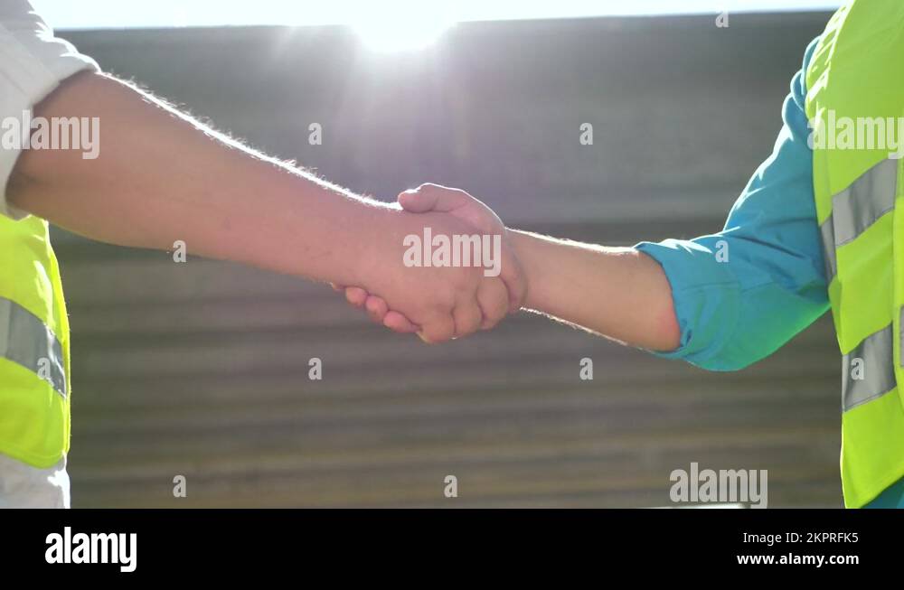 Close up of handshake in construction site. Employee or worker shake ...