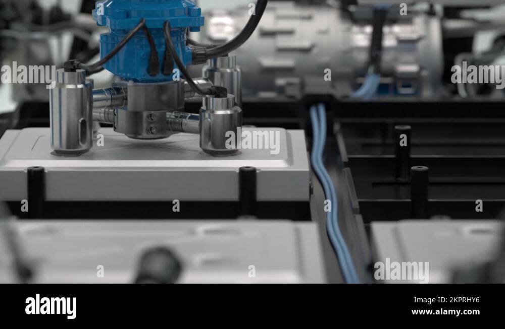Close-up side view of robots assembling the battery module of an ...