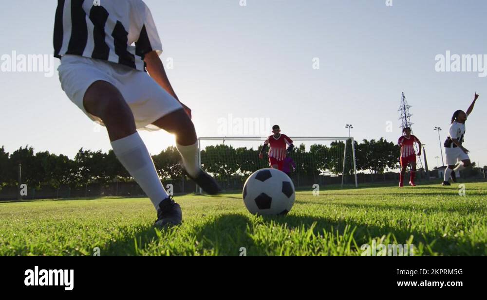 Video of diverse group of male football players playing football Stock ...