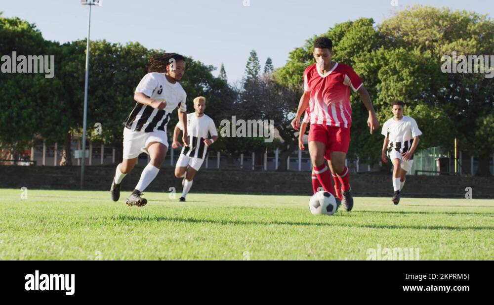 Video of diverse group of male football players on field, playing ...
