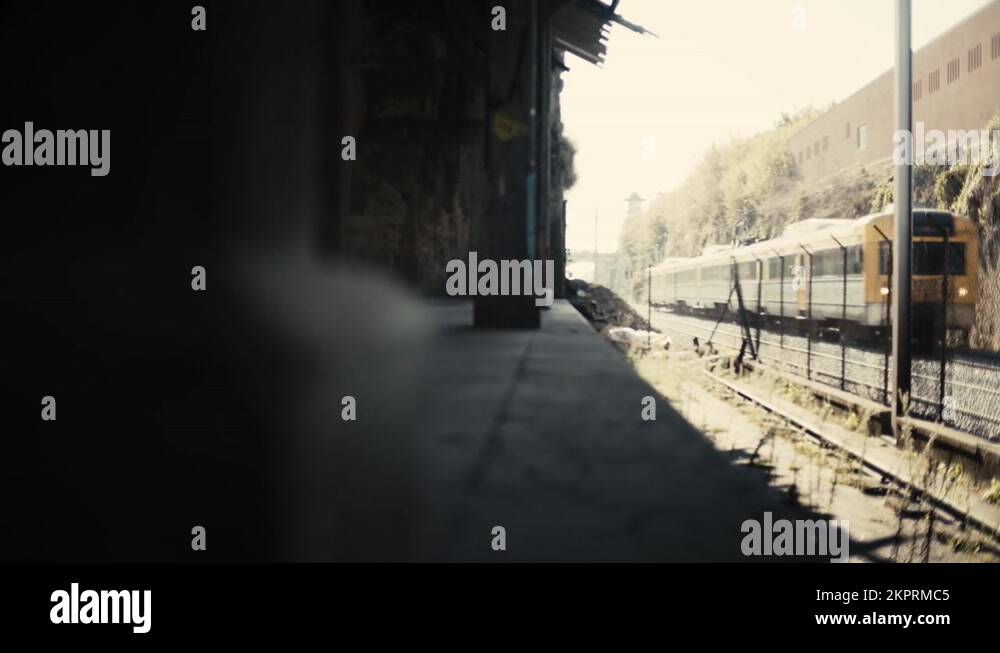 Old railway warehouse revealed by truck camera movement with train ...