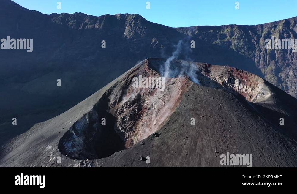 Smoldering active crater cone of Mount Rinjani Volcano in Indonesia ...
