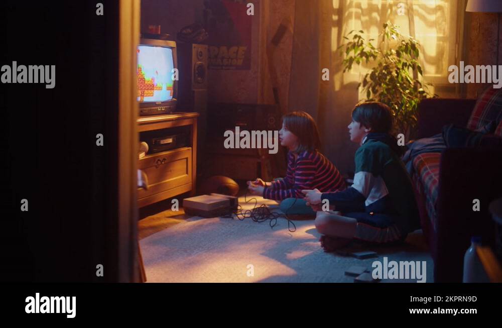Two Kids Playing Nostalgic Arcade Game at Home Stock Video Footage - Alamy