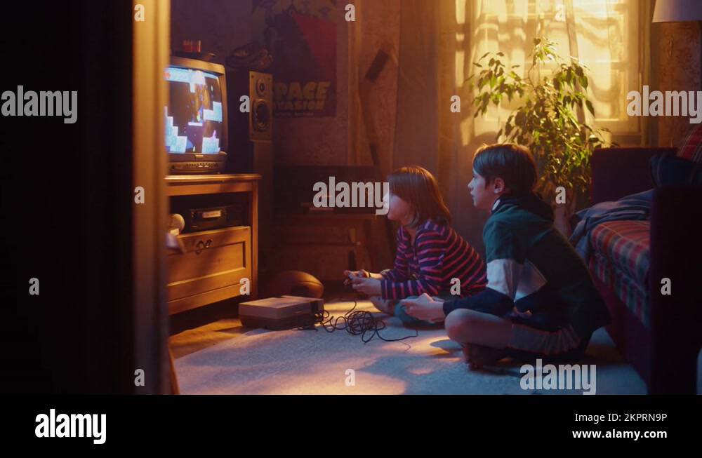 Two Kids Playing Nostalgic Arcade Game at Home Stock Video Footage - Alamy