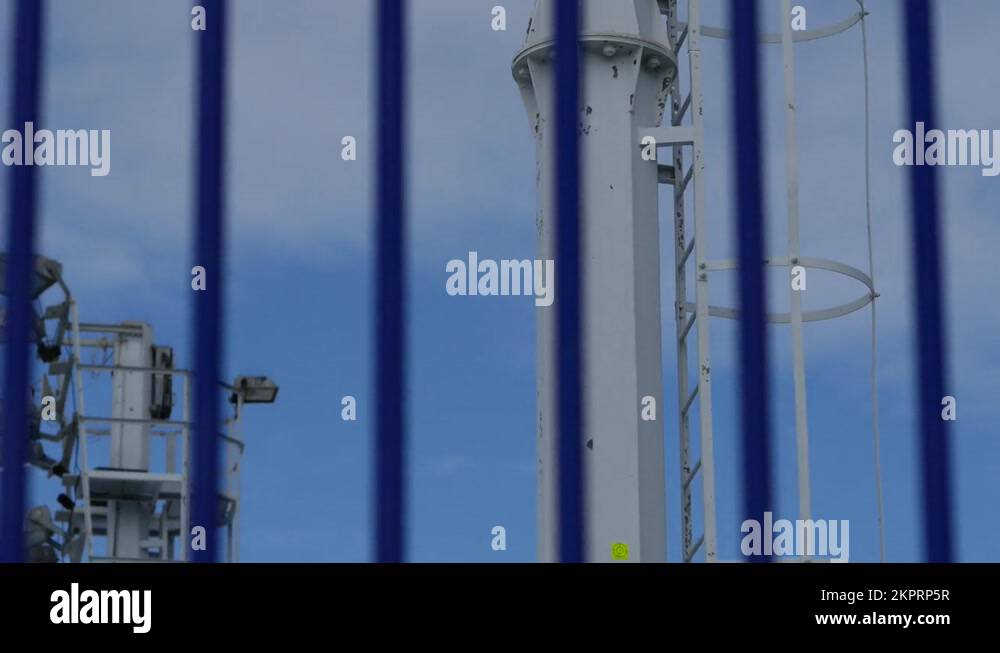 Ladder to a high steel rack. Tower with spotlights and cellular ...