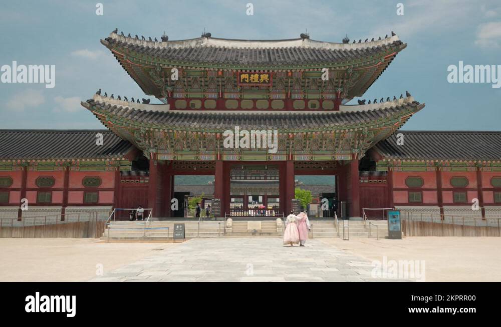 Back view of Korean Couple in Pink Hanbok clothes entering Heungnyemun ...