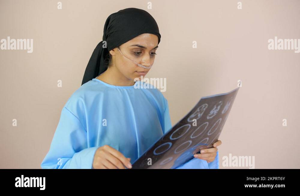 A young patient checking her X-ray / MRI / CT scan reports - a medical ...