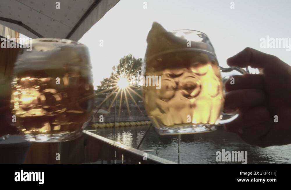 Beer glasses clinking in front of Charles Bridge with sunset in Stock ...