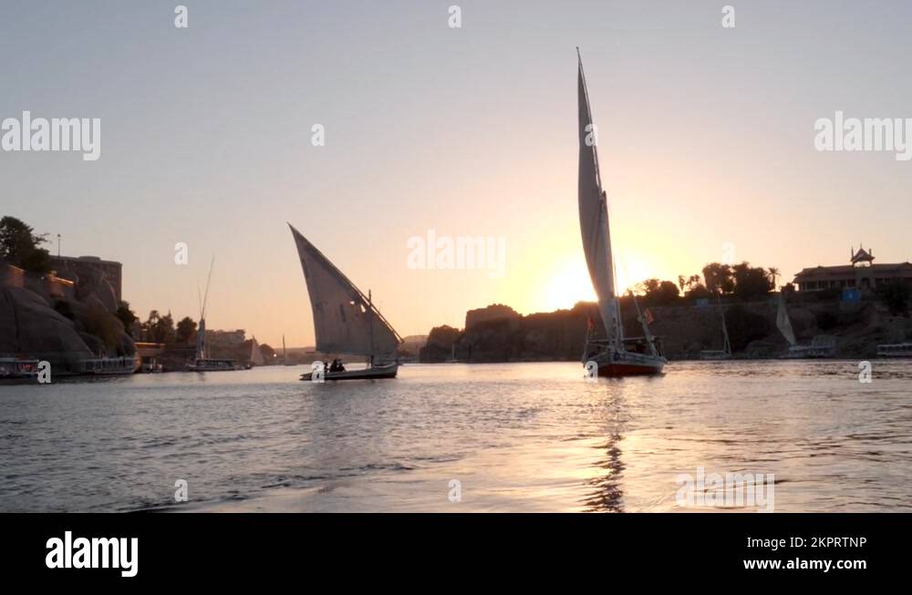 View of two feluccas during sunset sailing on the Nile river in Aswan ...
