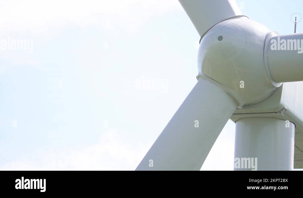Massive Blades Of Wind Turbine Rotate Against Clear Sky. Slow Motion ...