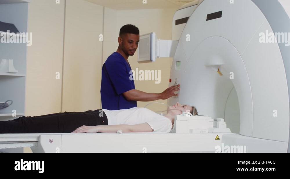 The medic sending the patient into the tunnel for brain MRI Stock Video ...