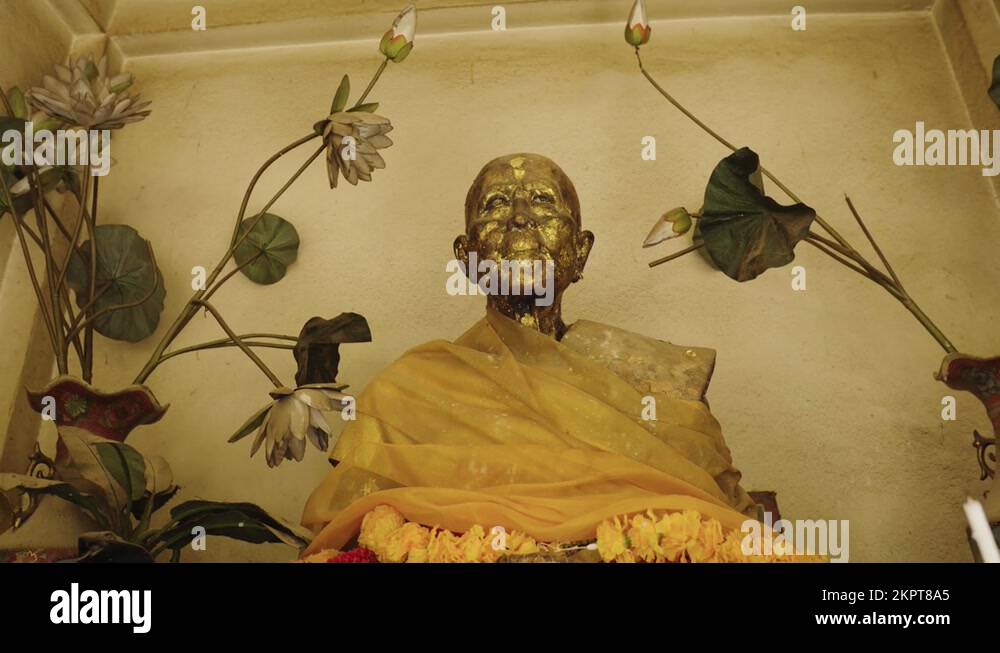 Old monk statue with lotus flowers in Thai Buddhist temple Stock Video ...