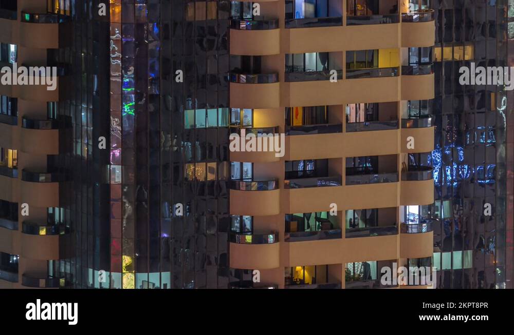 Night aerial view of office or apartment building glass window facade ...