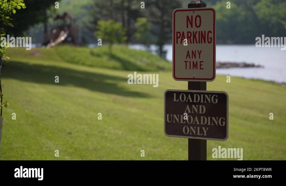 Signs at a beach for No Parking and Loading and Unloading Only Stock ...